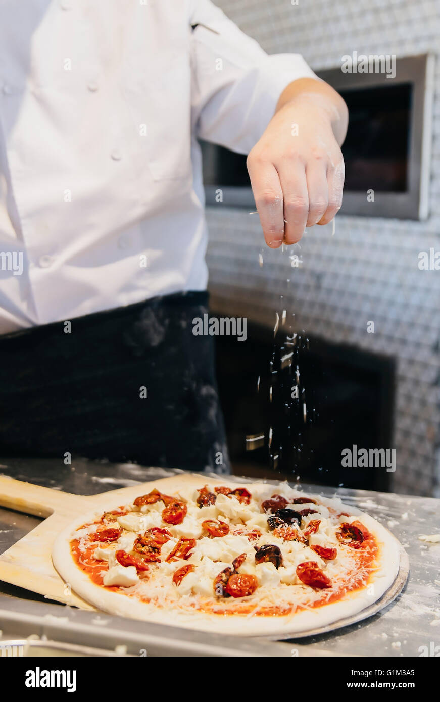 Chef making pizza in restaurant in kitchen Stock Photo - Alamy
