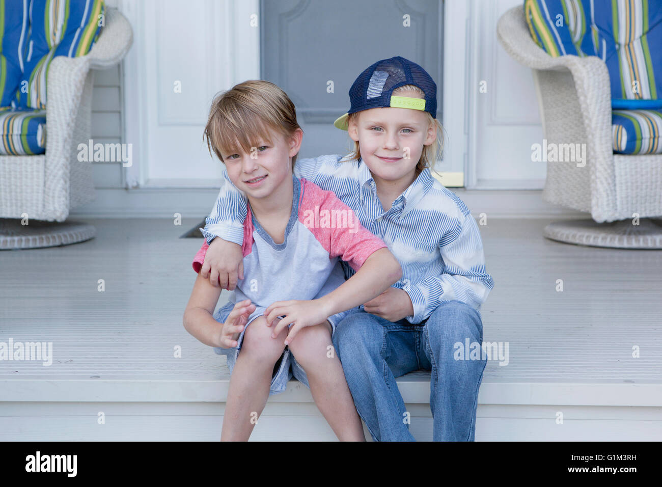 Caucasian boys hugging on porch Stock Photo - Alamy