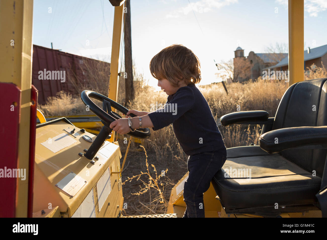 Caucasian preschooler boy driving tractor Stock Photo - Alamy
