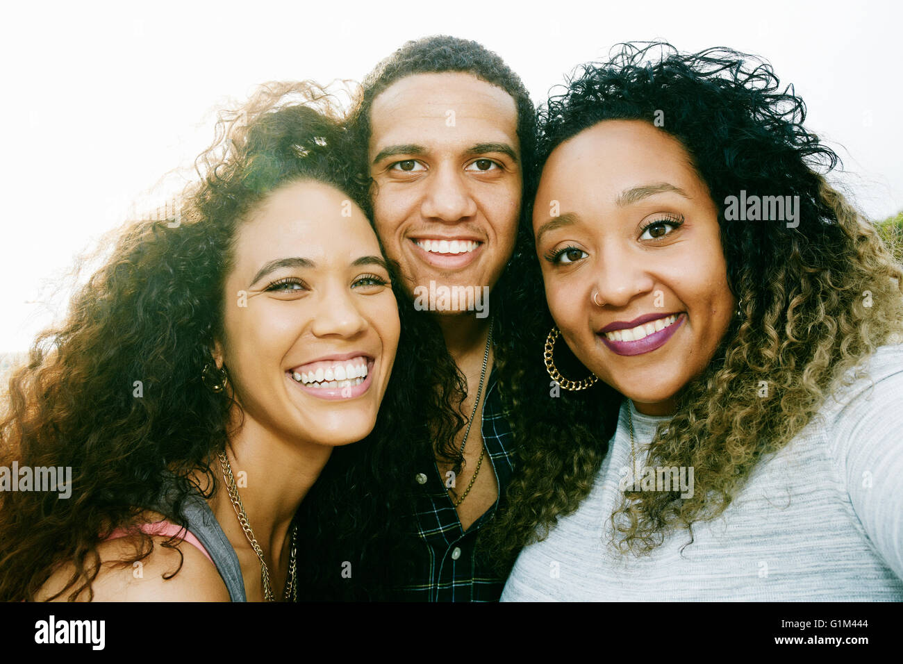 Friends smiling outdoors Stock Photo - Alamy