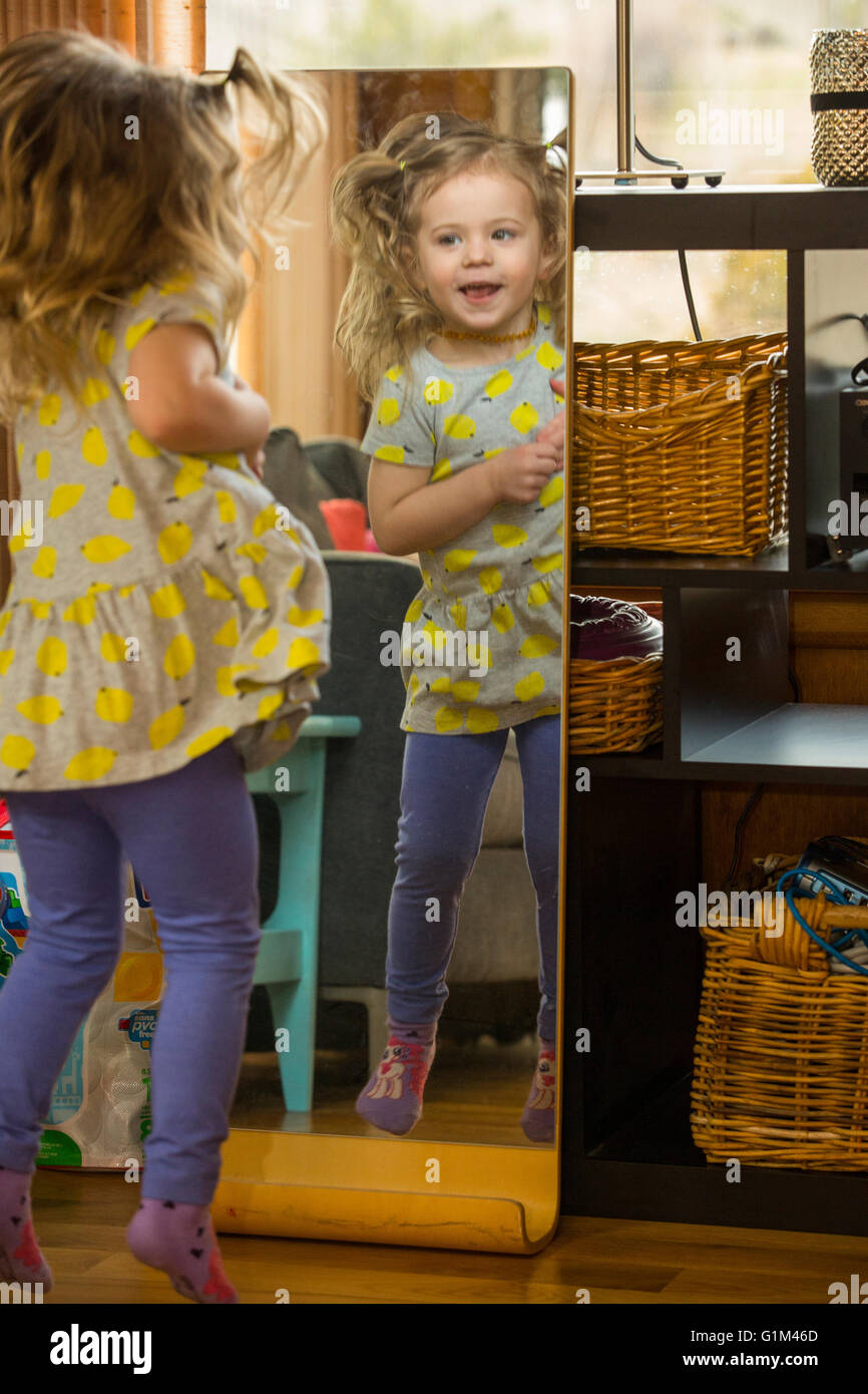 Caucasian preschooler girl admiring herself in mirror Stock Photo - Alamy