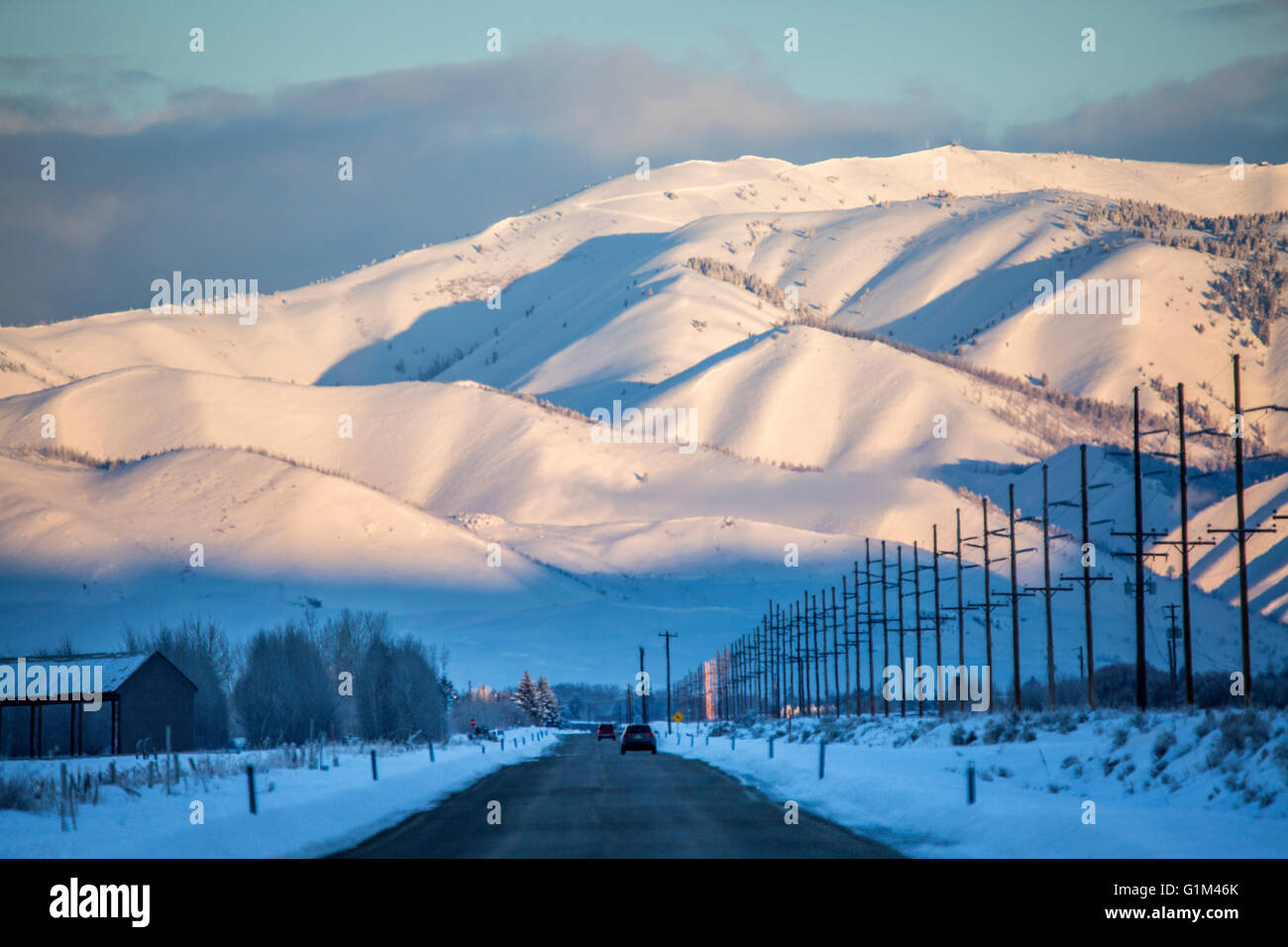 Snowy mountains over road in remote landscape Stock Photo - Alamy
