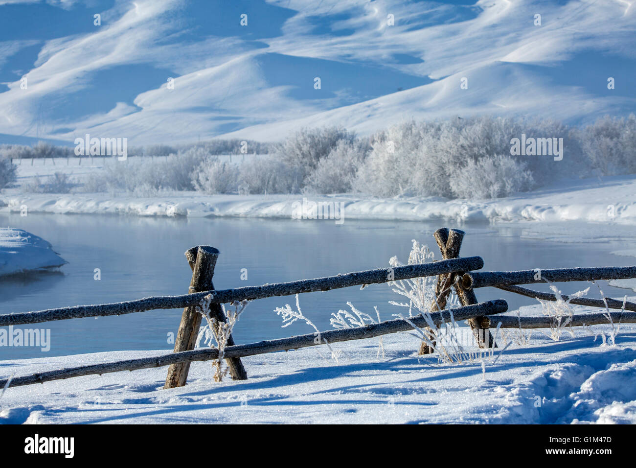 Fence and river in snowy rural landscape near river Stock Photo - Alamy