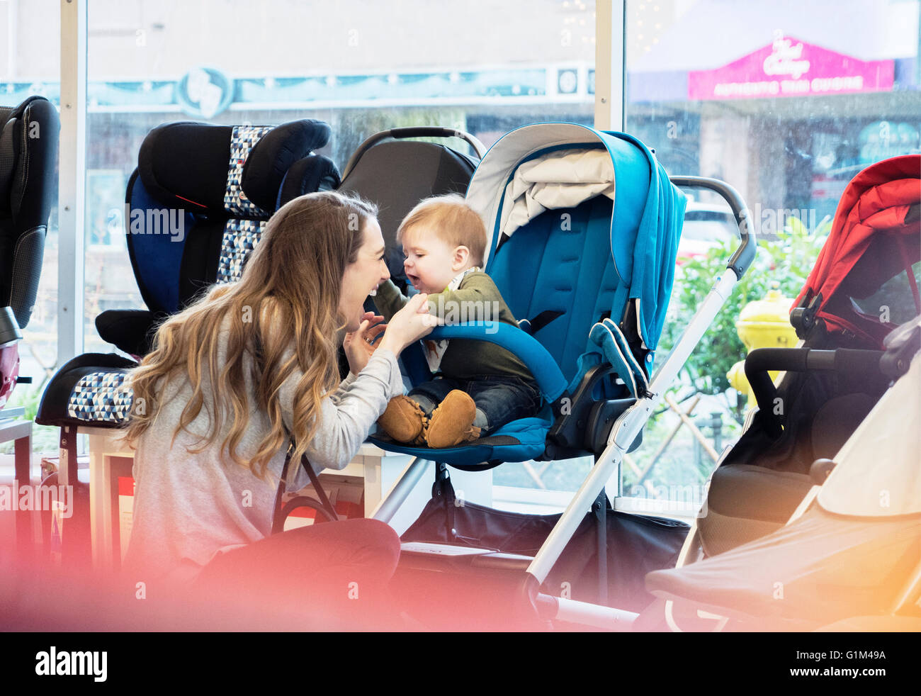 Caucasian mother and baby son shopping in stroller store Stock Photo ...