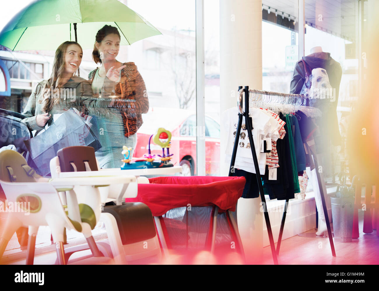 Caucasian women window shopping outside store Stock Photo - Alamy
