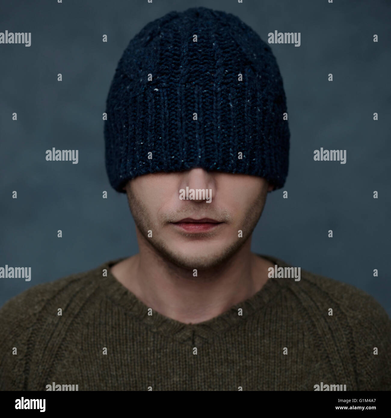 Caucasian man wearing beanie hat over eyes Stock Photo - Alamy