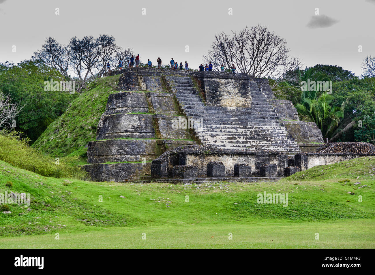 Tourists observe the ruins from the top of Temple of the Masonry ALtars ...