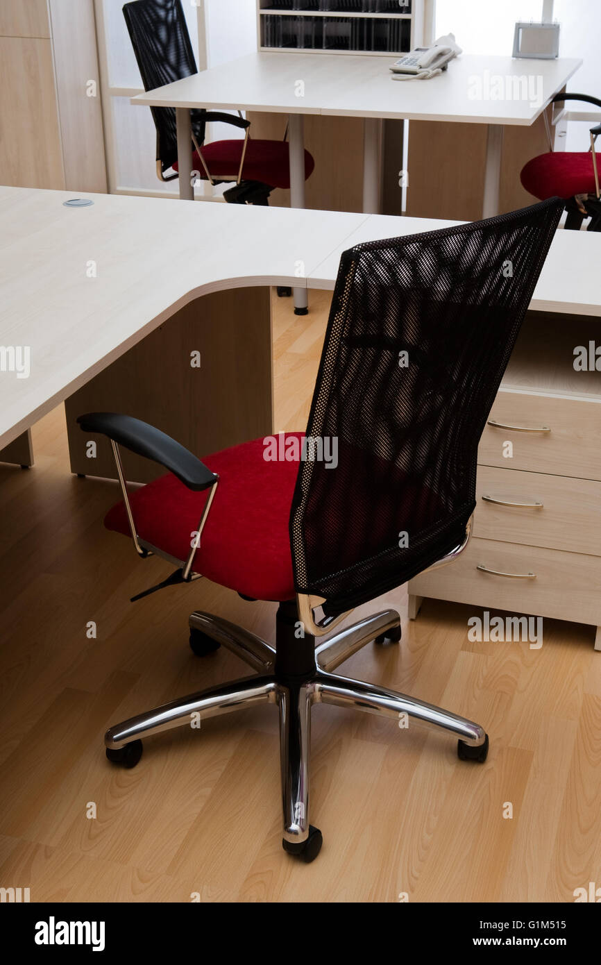 new red chair in a modern office Stock Photo - Alamy