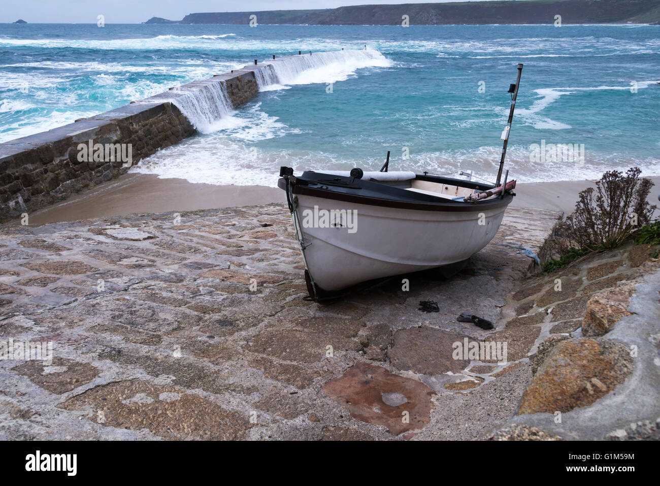 Sennen Cove harbour with boat and angry sea Stock Photo - Alamy