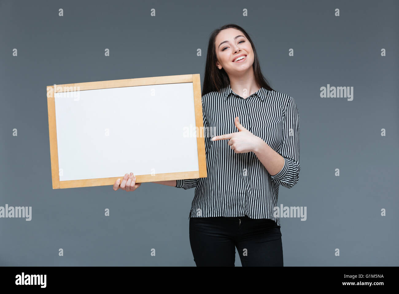 Woman pointing finger on blank board hi-res stock photography and ...