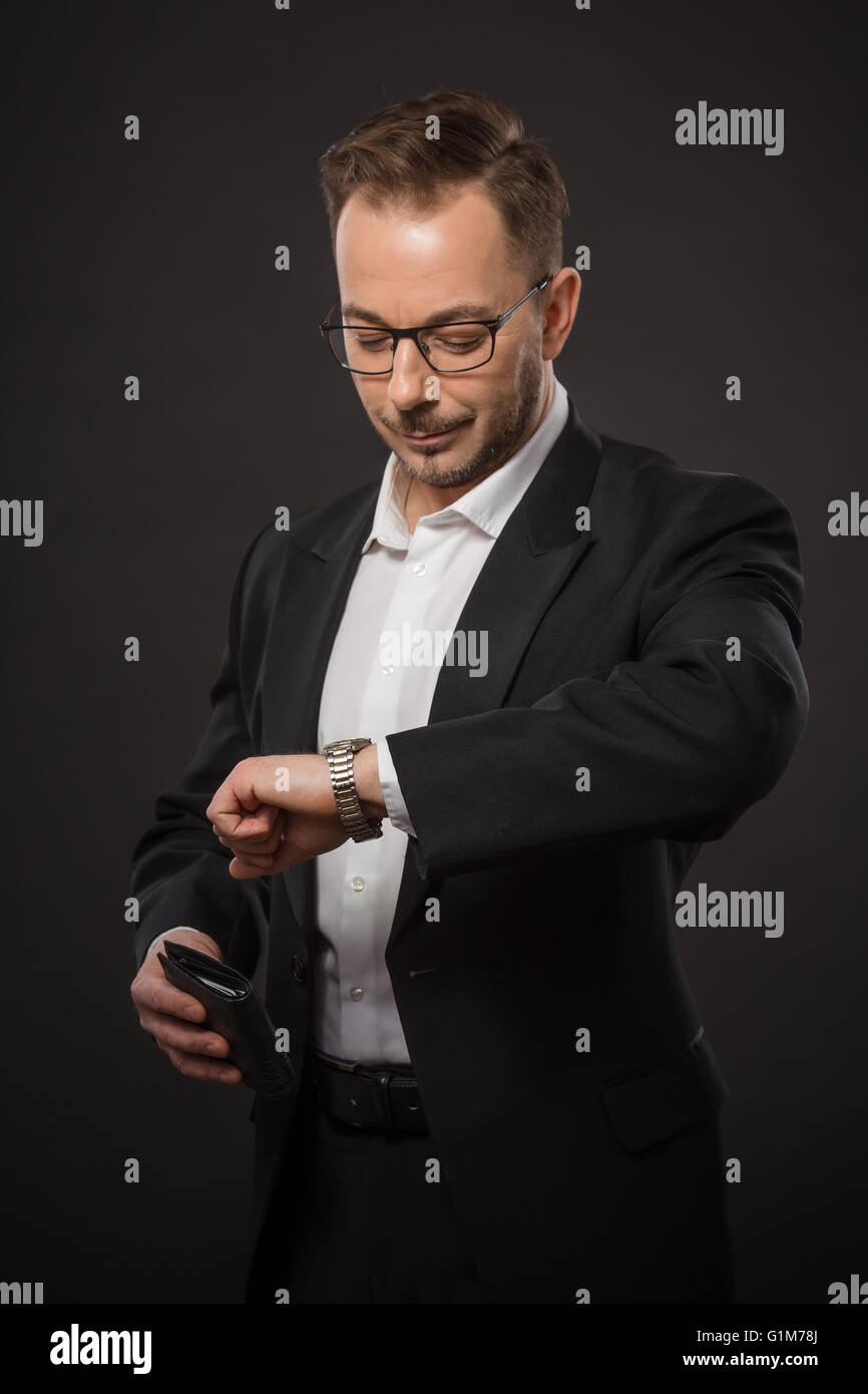 Businessman checking time Stock Photo - Alamy