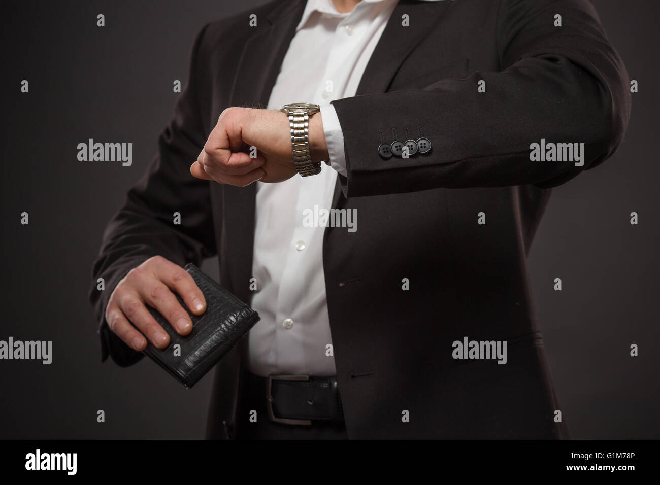 Office worker checking the time hi-res stock photography and images - Alamy