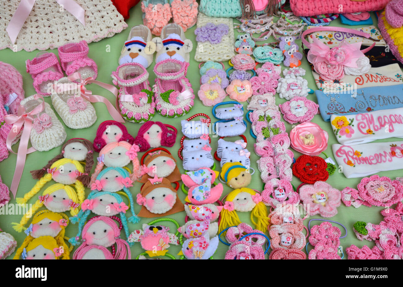 Craft stall display of wollen knitted, multicoloured goods. In centre ...