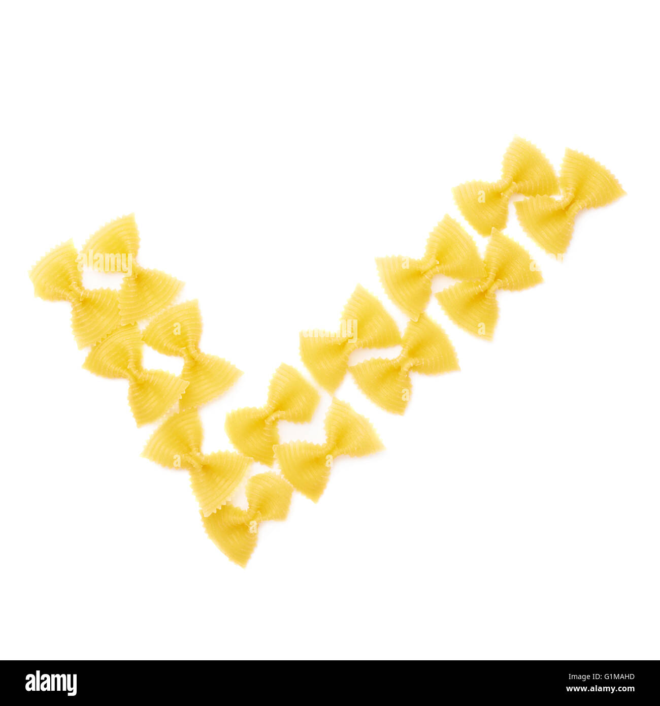 Yes tick sign symbol mark made of dry pasta farfalle over isolated ...