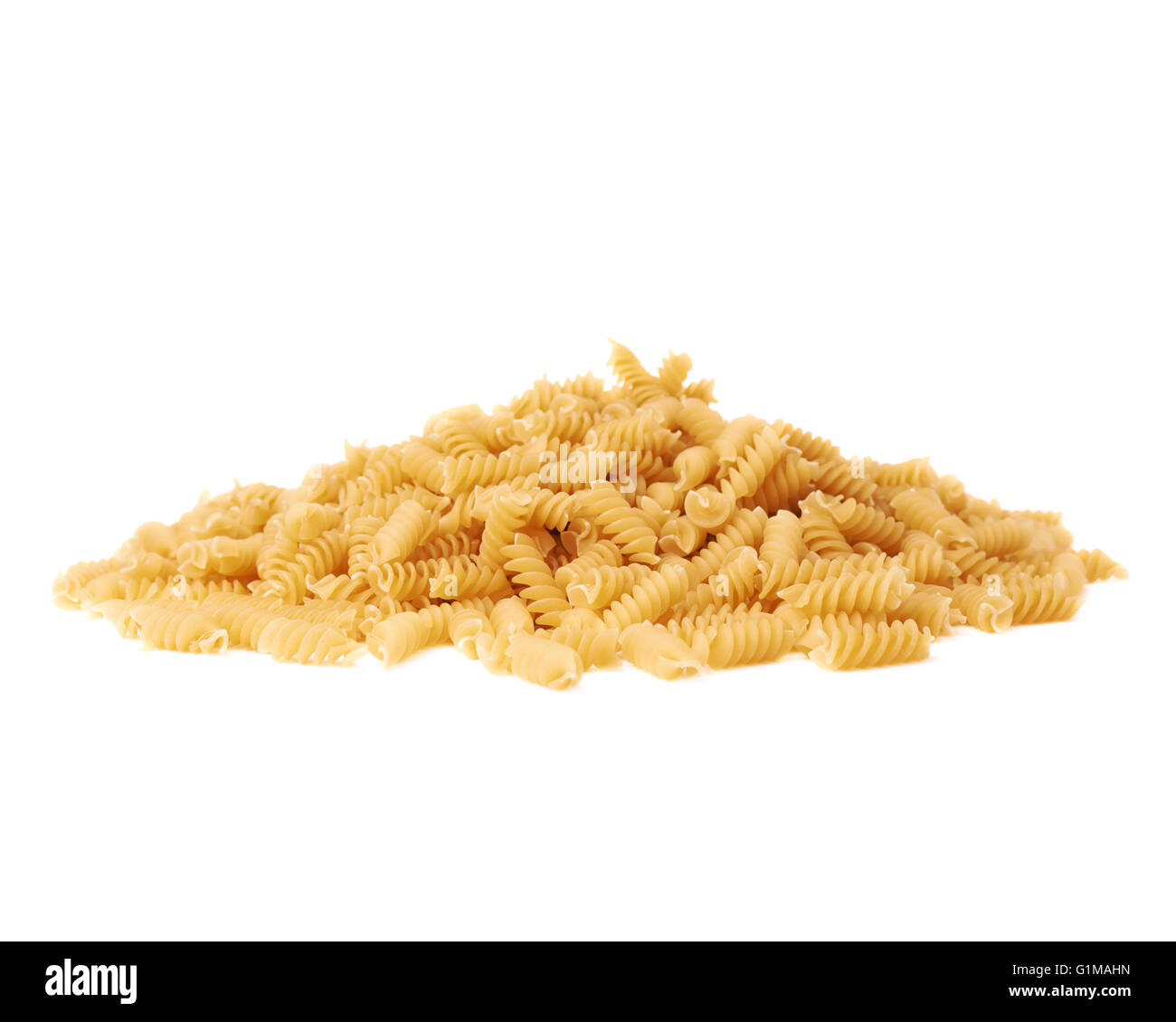 Pile of dry rotini pasta over isolated white background Stock Photo - Alamy