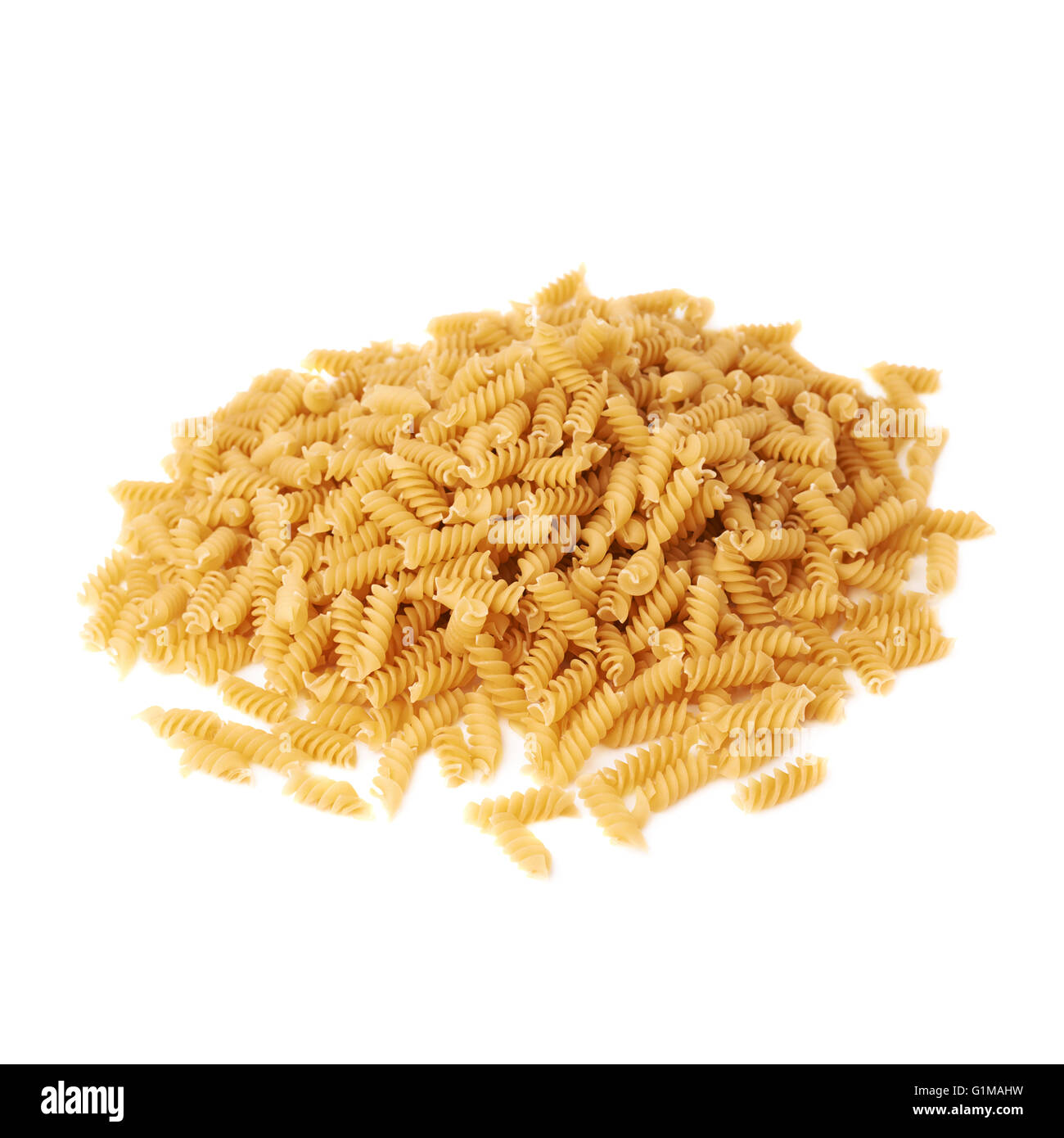 Pile of dry rotini pasta over isolated white background Stock Photo - Alamy
