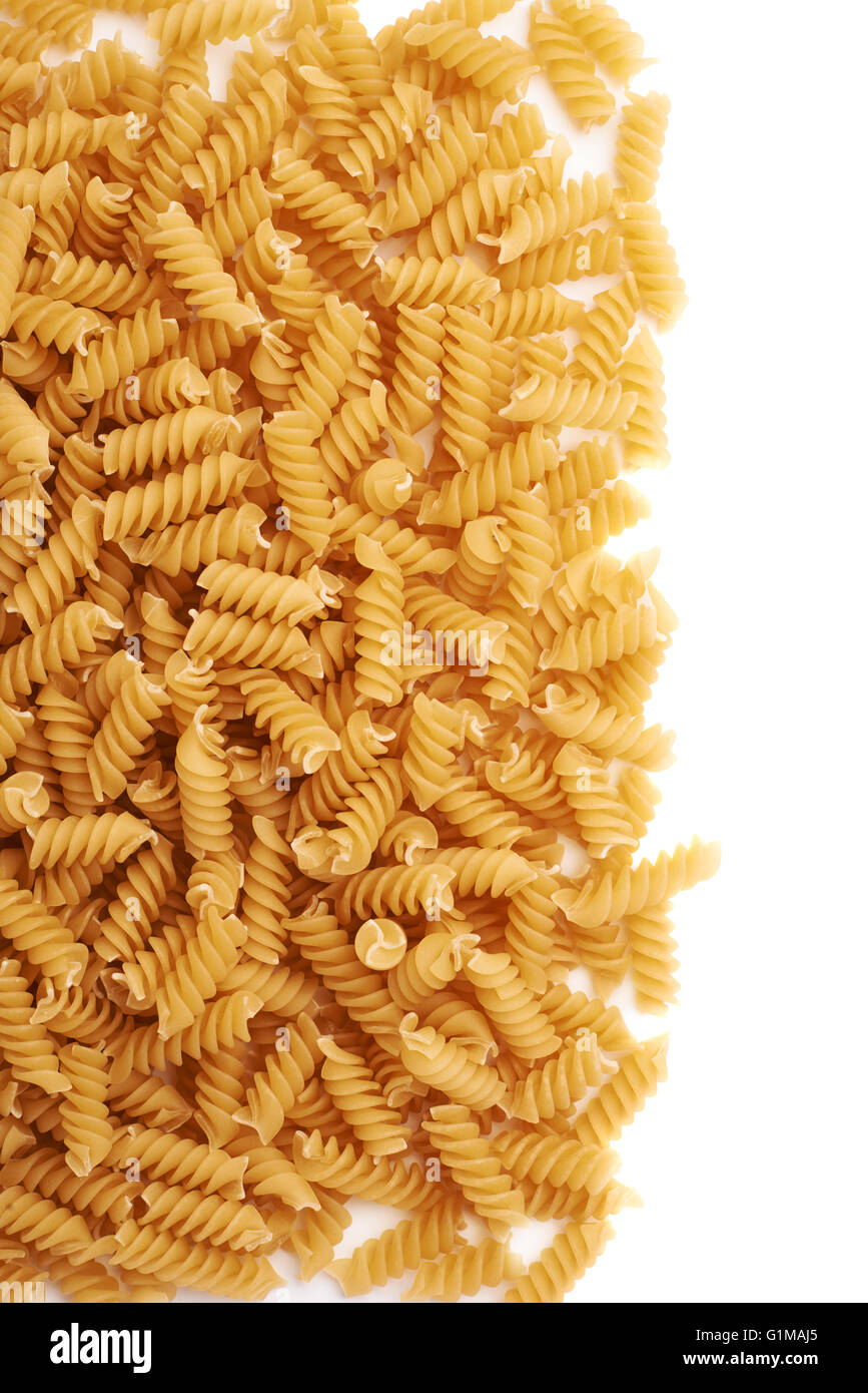 Pile of dry rotini pasta over isolated white background Stock Photo - Alamy