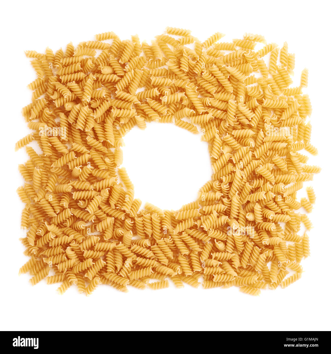 Round frame made of dry rotini pasta over isolated white background ...