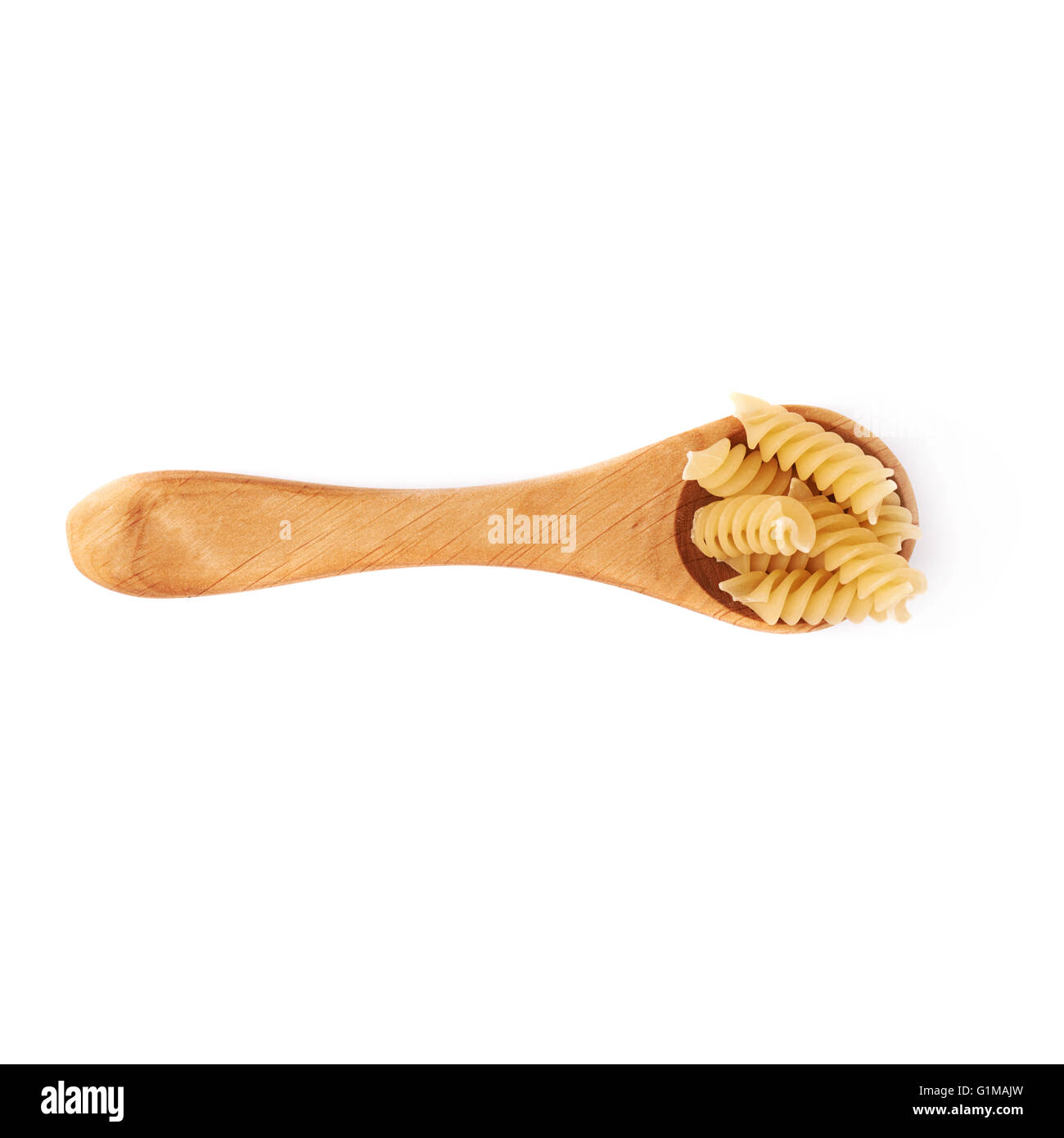 Wooden spoon filled with dry rotini pasta over isolated white ...