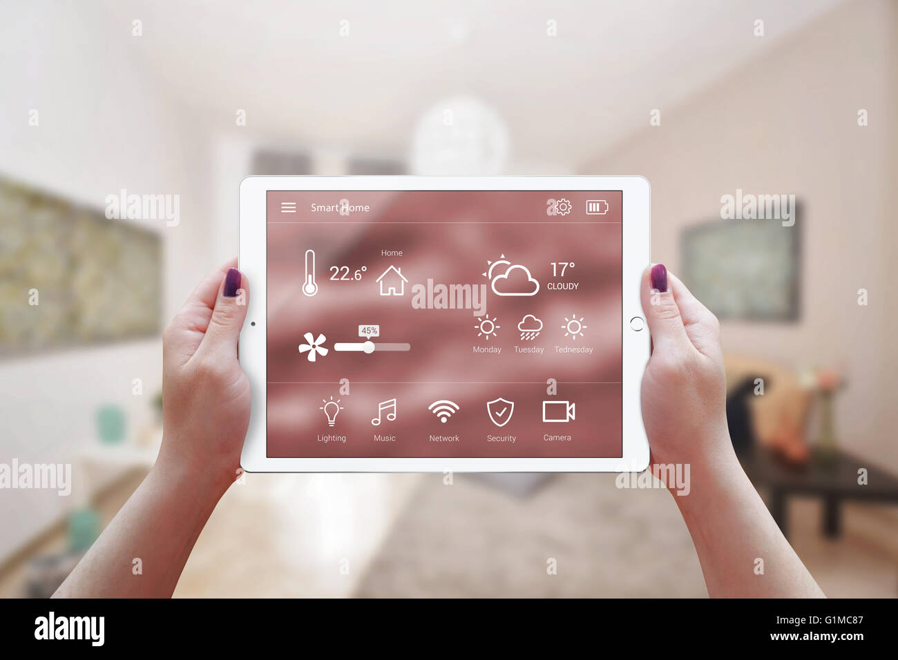 Smart remote home control app in woman hand. Living room interior in ...