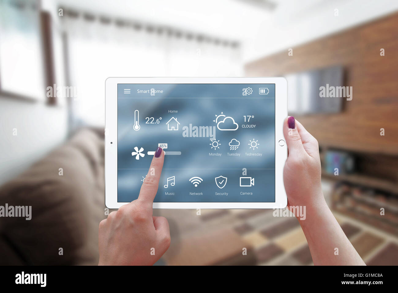Smart home control on tablet. Interior of living room in the background ...