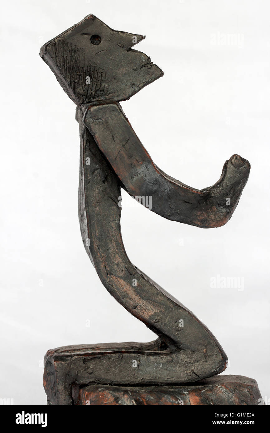Ceramic stick man praying pottery sculpture Stock Photo - Alamy