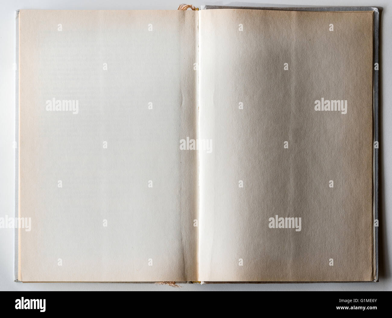 Old grunge book opened to the last page showing aged textured paper ...