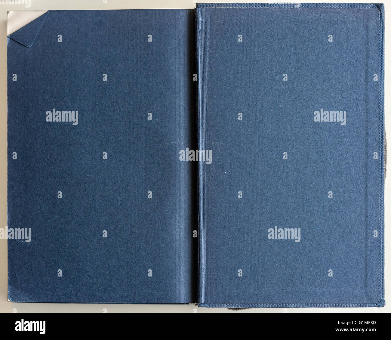 Book opened to the first page showing blank blue pages inside Stock ...