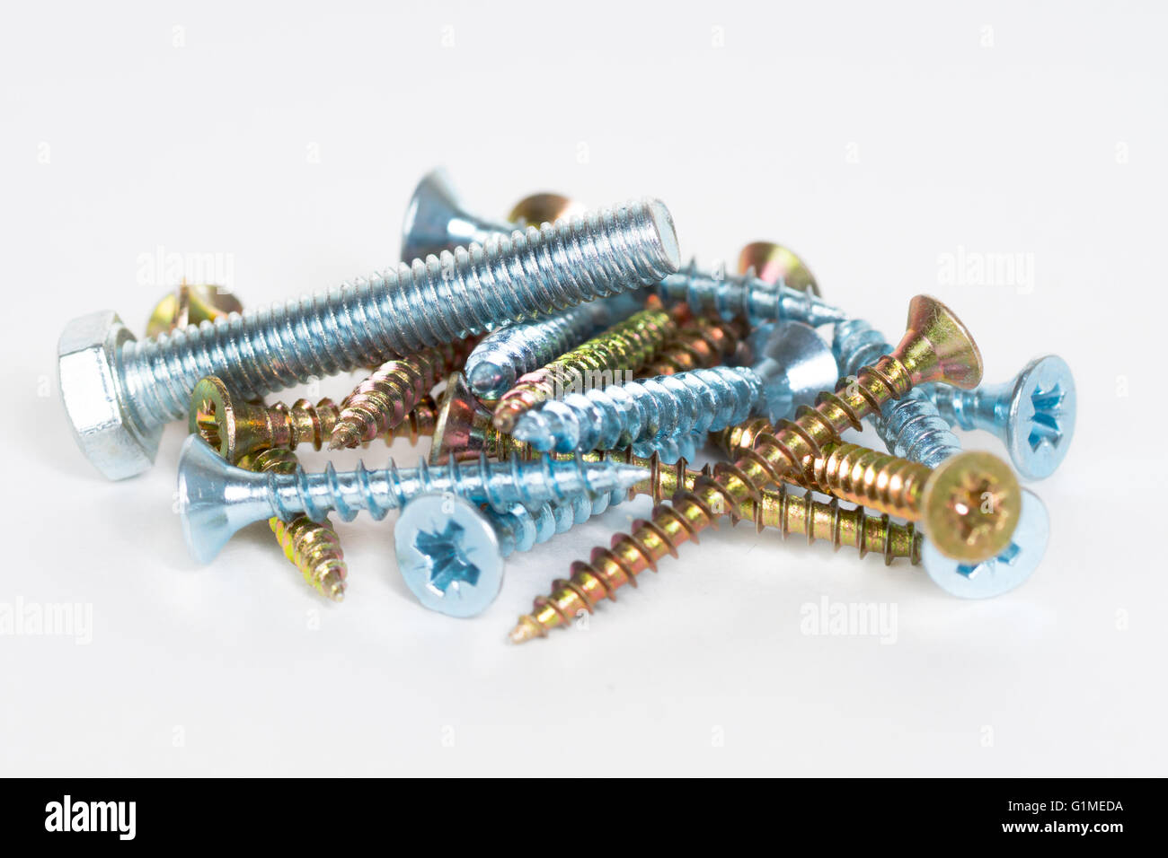golden and silver screws, bolts on white background Stock Photo - Alamy