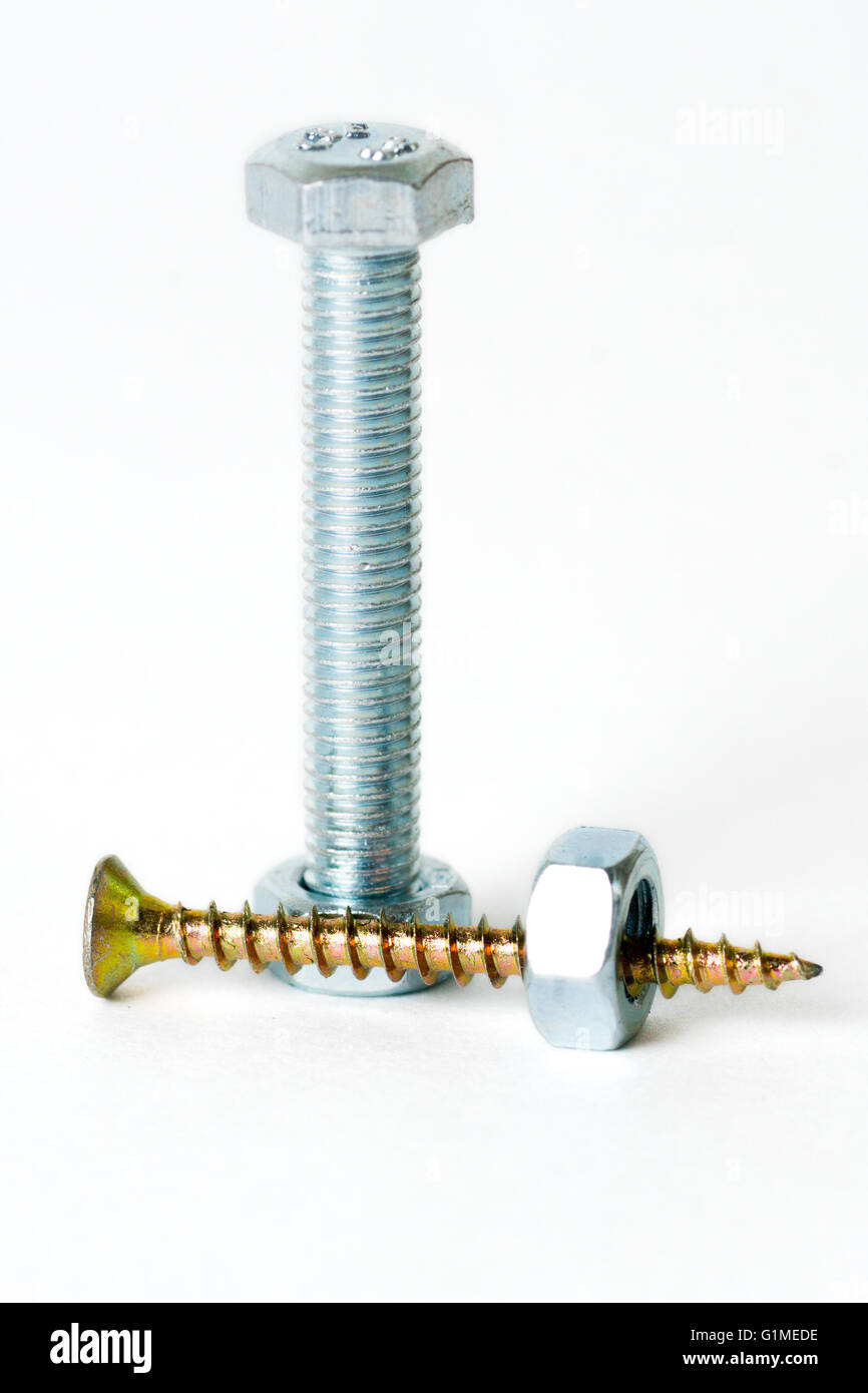 small golden screws, silver bolt and big silver nut Stock Photo - Alamy