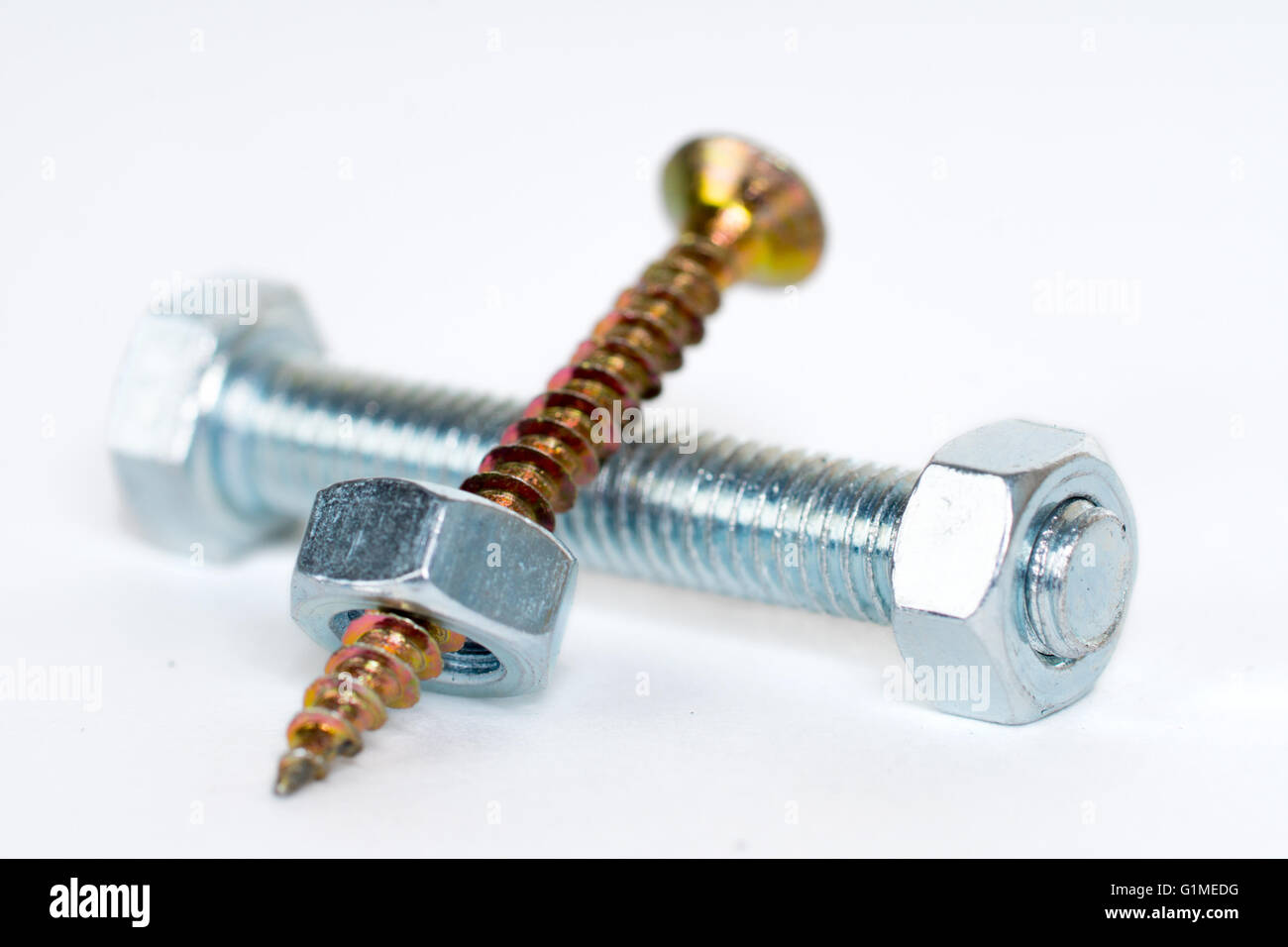 small golden screws, silver bolt and big silver nuts Stock Photo - Alamy