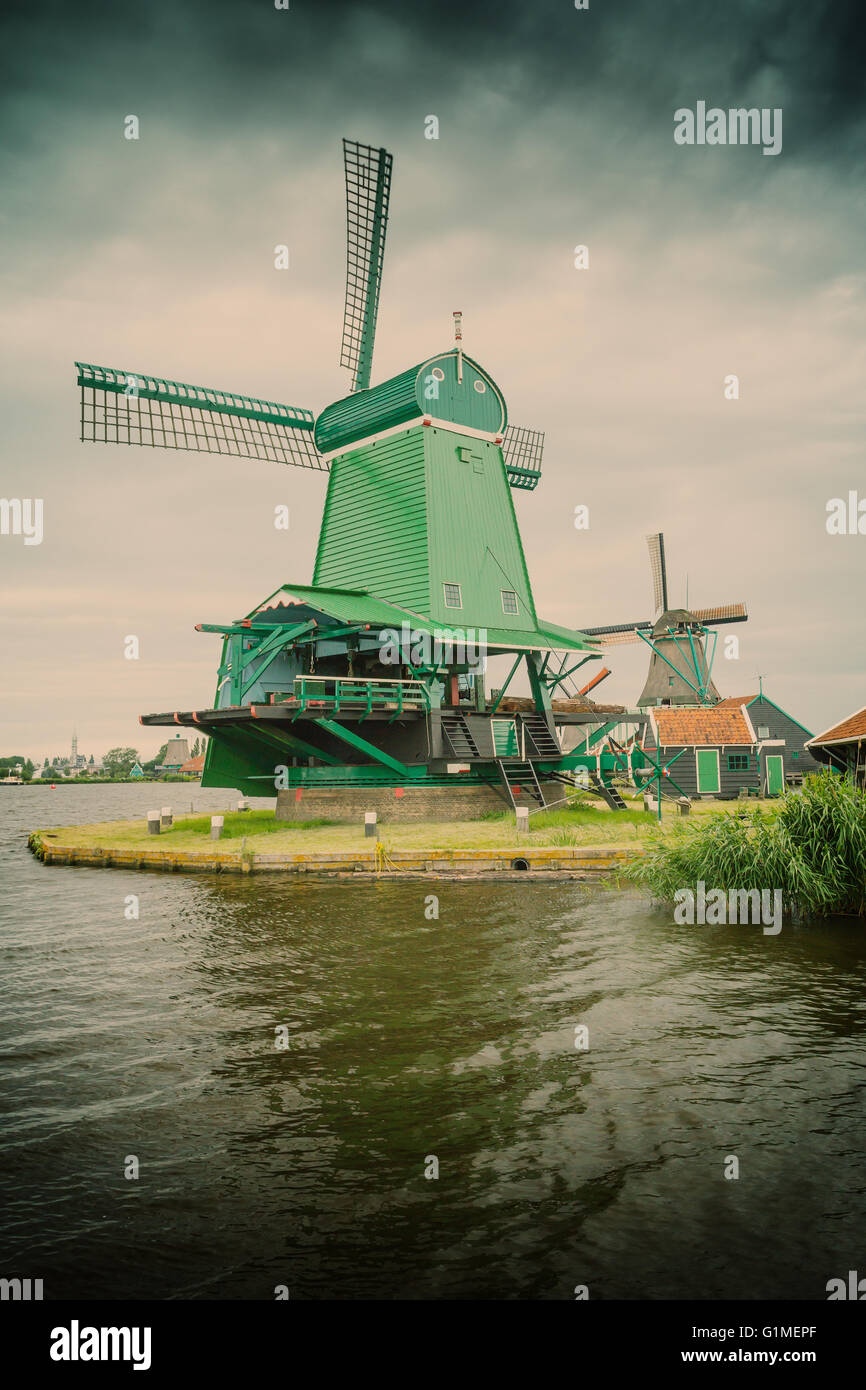 Vintage photo of traditional windmill in Netherlands. The green ...