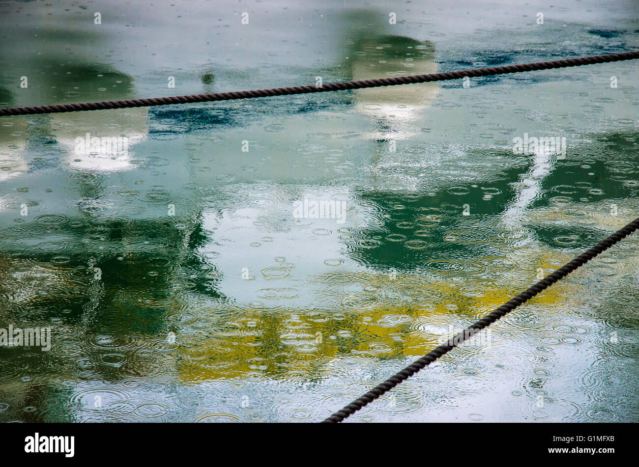 raindrops in sea water surface and colorful boat reflection Stock Photo ...