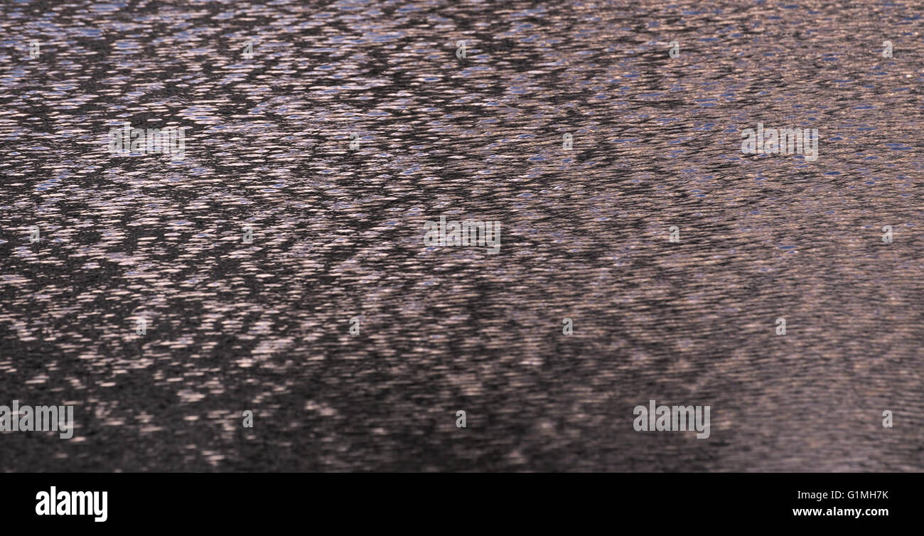 Blue reflections of sunset on a rippled lake Stock Photo - Alamy
