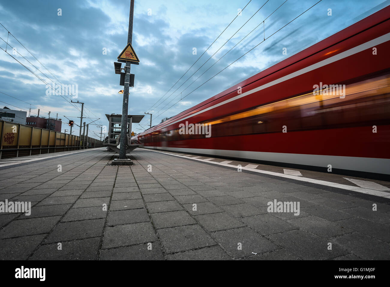 A red DB train leaving the station Stock Photo - Alamy