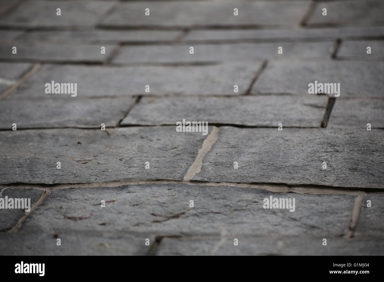Paved ground with defocus effect usable as background Stock Photo - Alamy