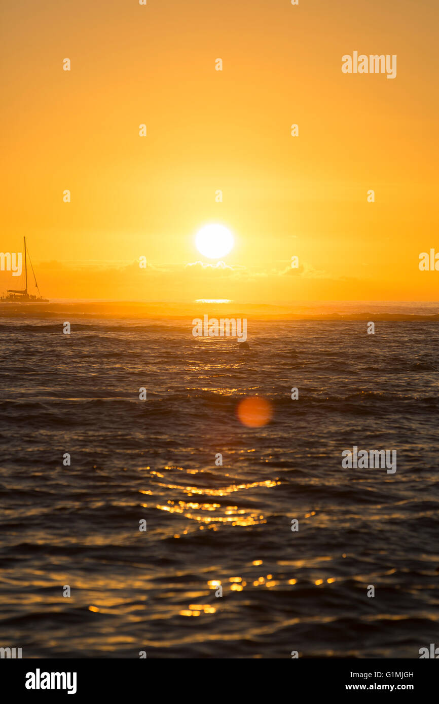 The sun sets over the ocean Stock Photo - Alamy