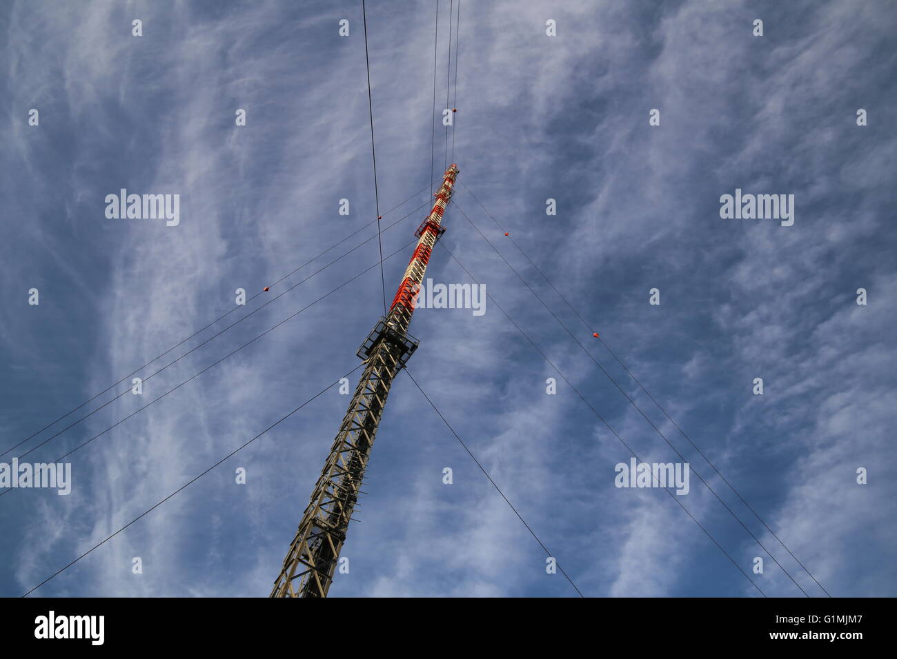 Red and white radio tower in unusual angle Stock Photo - Alamy