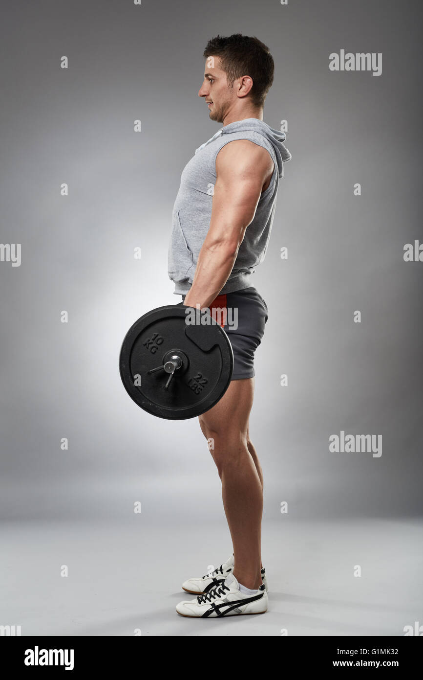 Man doing deadlift for back workout with barbell Stock Photo - Alamy