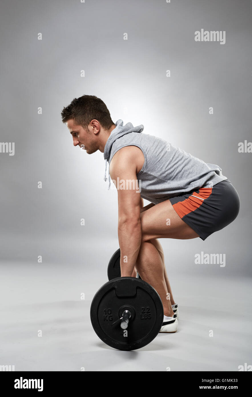 Muscular man lifting barbell back hi-res stock photography and images ...
