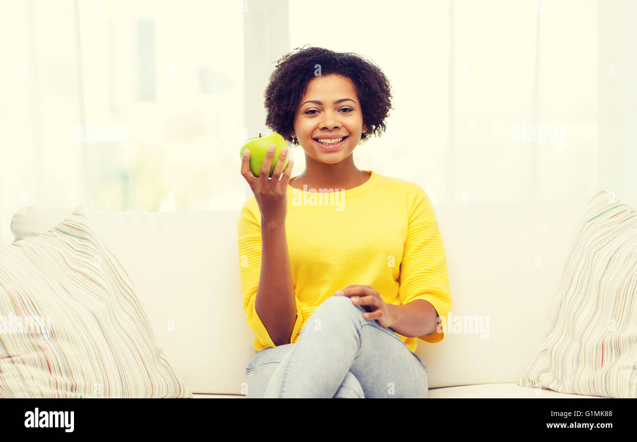 happy african american woman with green apple Stock Photo - Alamy