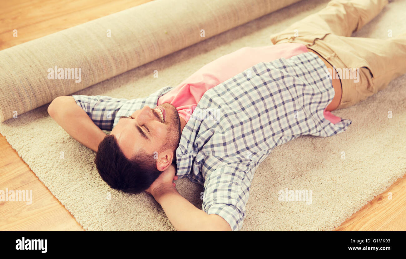 happy man lying carpet or rug at home Stock Photo - Alamy