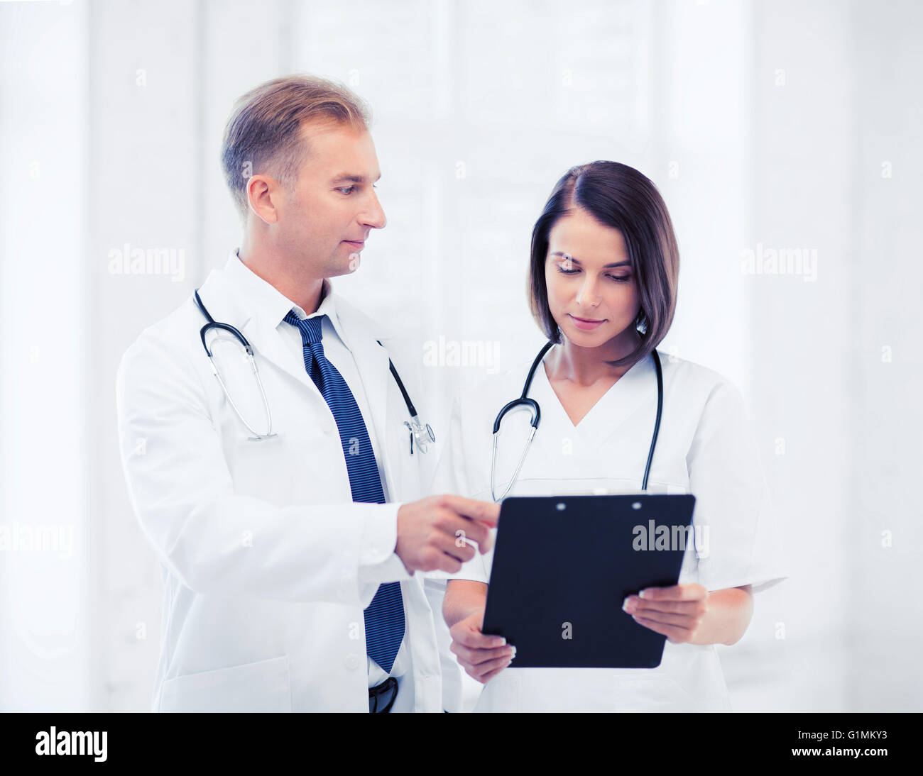 two doctors writing prescription Stock Photo - Alamy