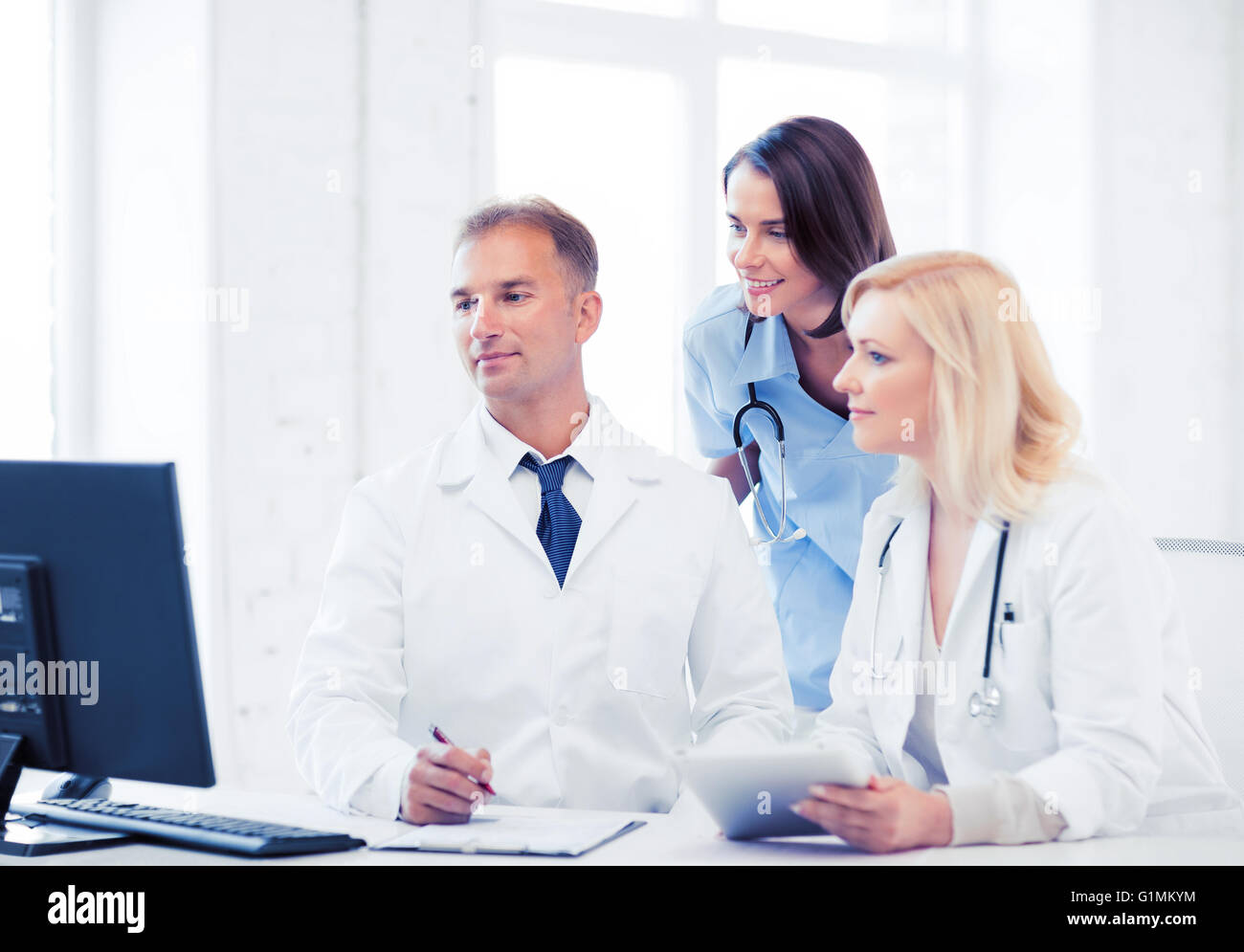 doctors looking at computer on meeting Stock Photo - Alamy