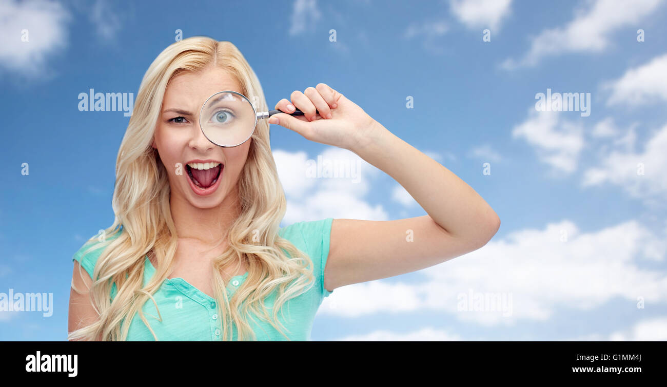 happy young woman with magnifying glass Stock Photo - Alamy