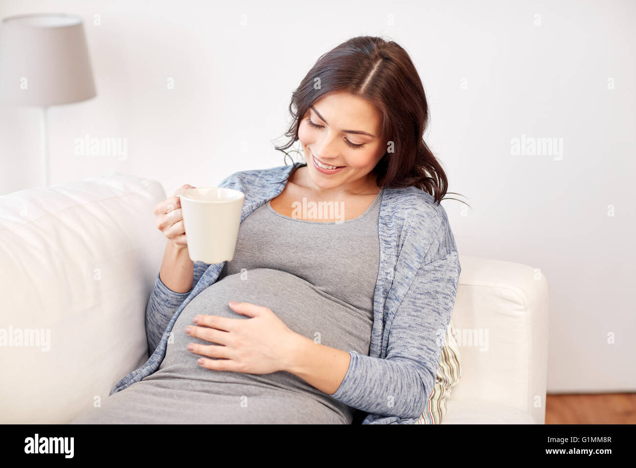 happy pregnant woman with cup drinking tea at home Stock Photo - Alamy