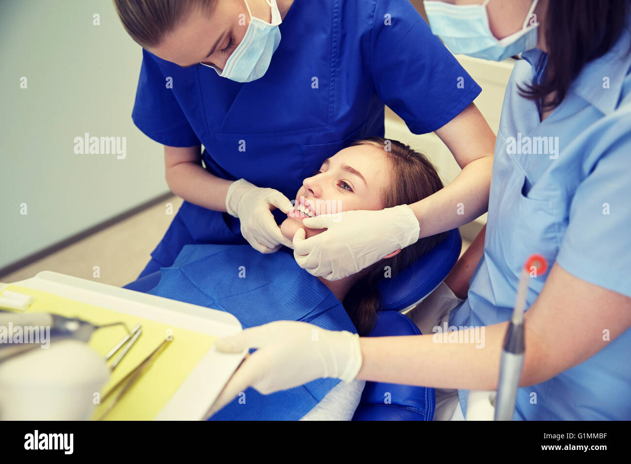 happy female dentist with patient girl at clinic Stock Photo - Alamy