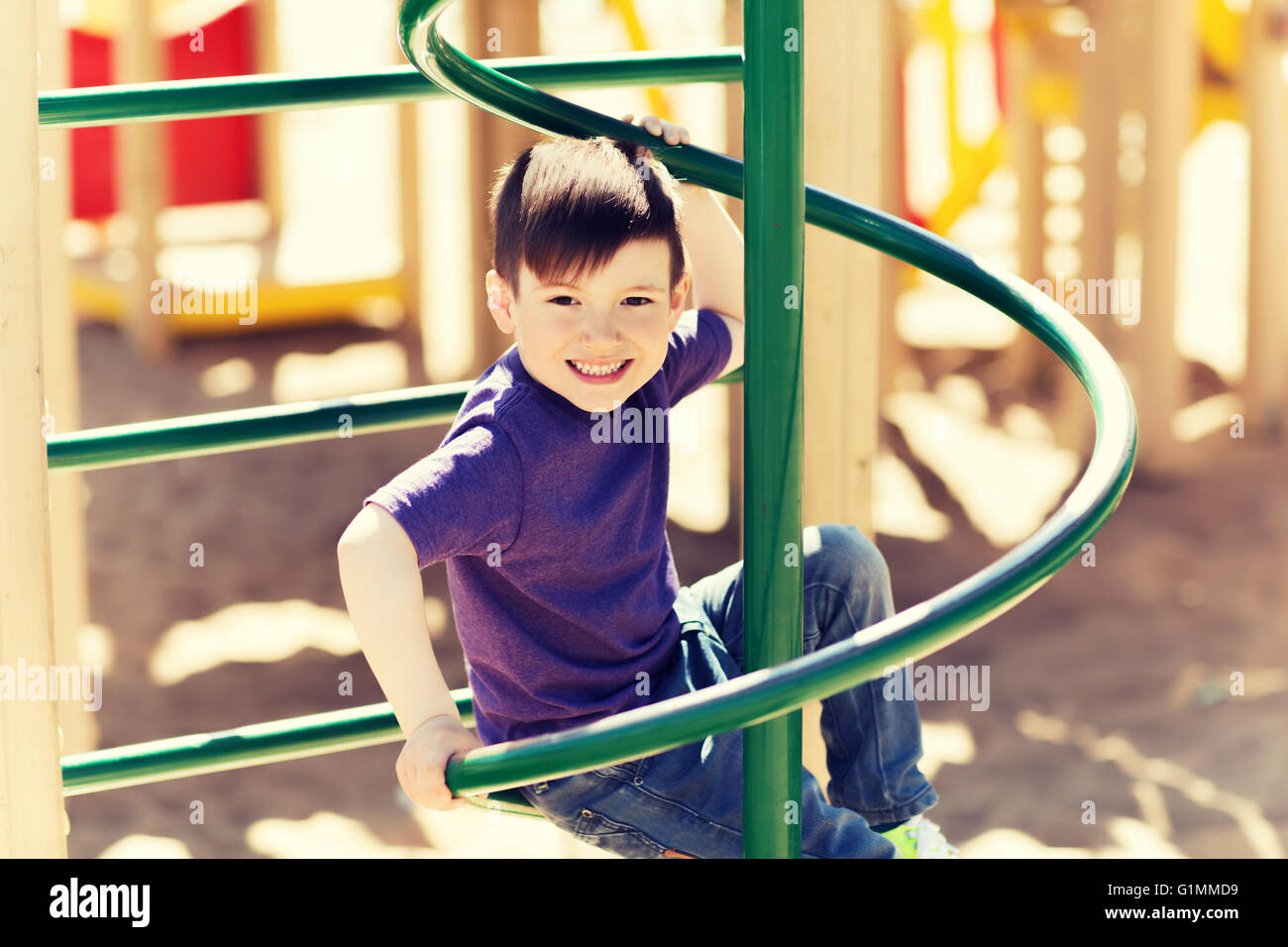 happy little boy climbing on children playground Stock Photo - Alamy