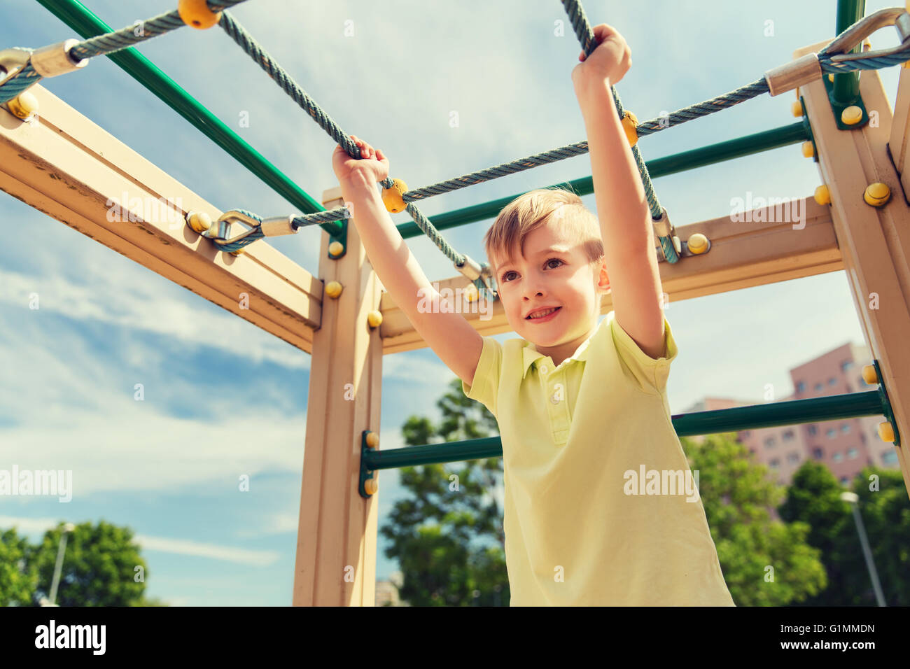 happy little boy climbing on children playground Stock Photo - Alamy