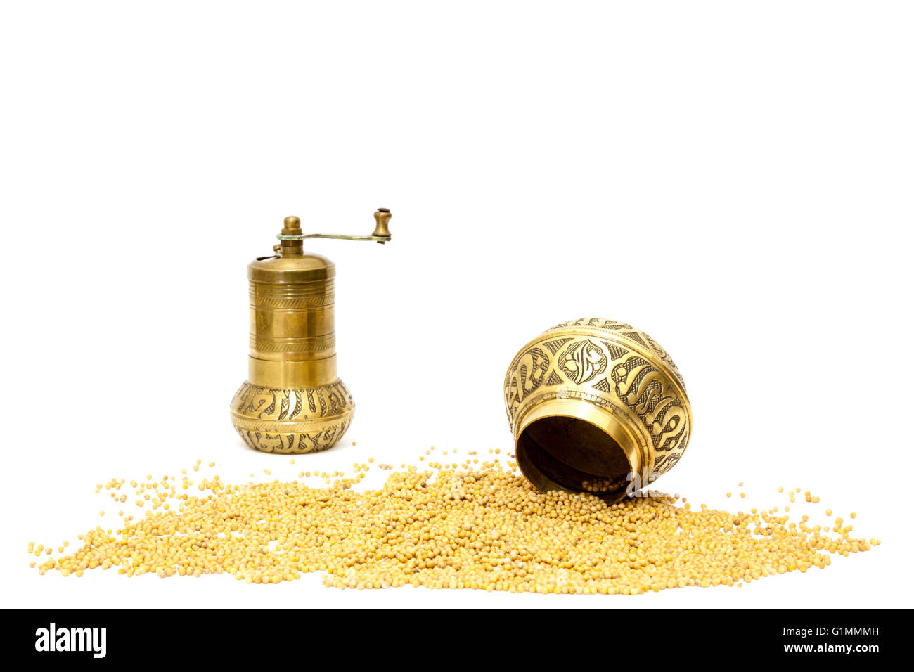 White or yellow mustard seeds with spice bowl and grinder isolated on a ...